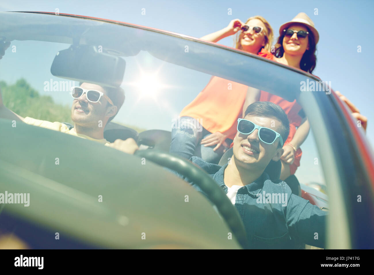 happy friends driving in cabriolet car Stock Photo - Alamy
