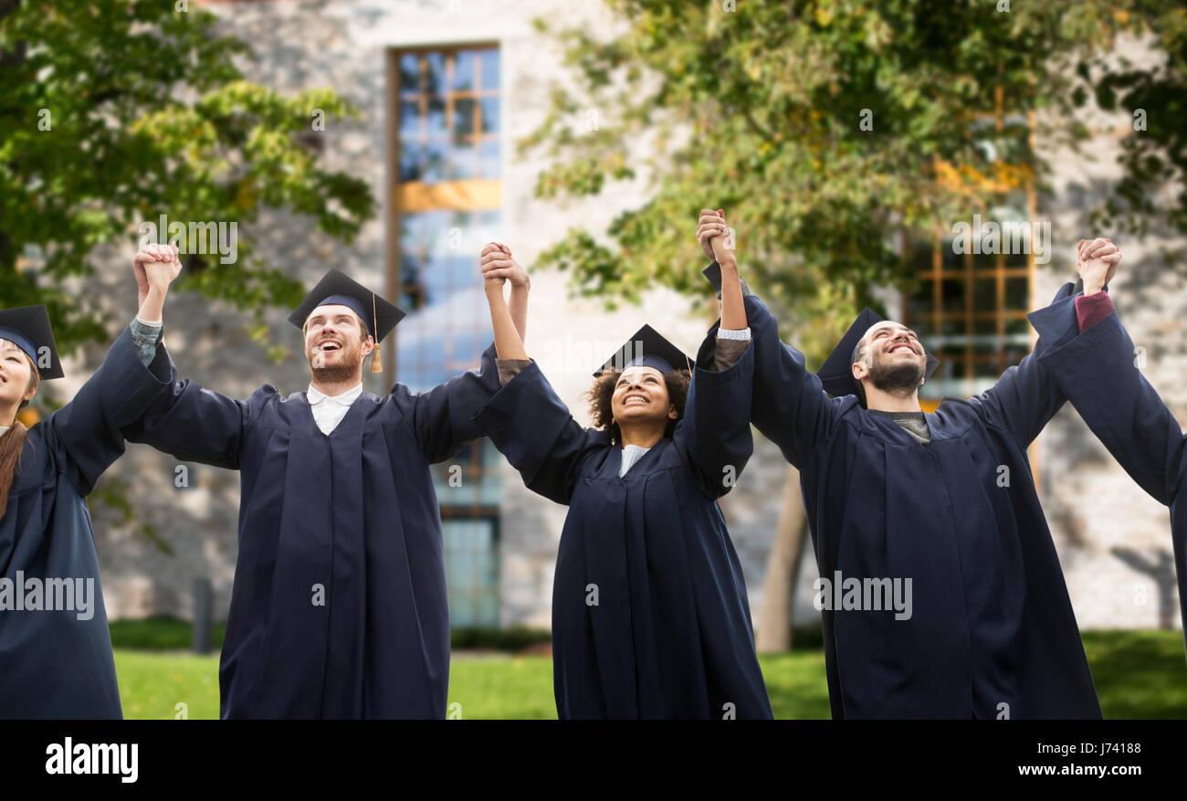 happy students or bachelors celebrating graduation Stock Photo - Alamy