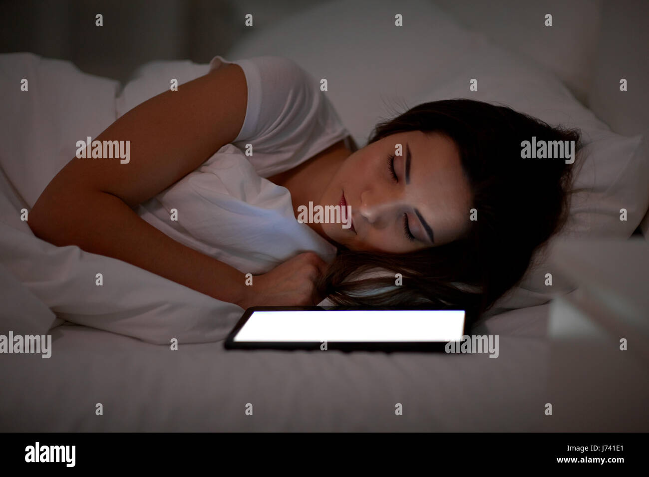 woman with tablet pc sleeping in bed at night Stock Photo - Alamy