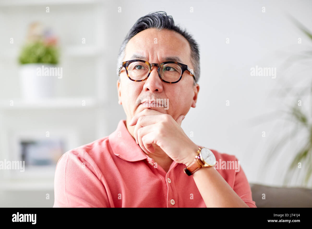 asian man thinking at home Stock Photo - Alamy