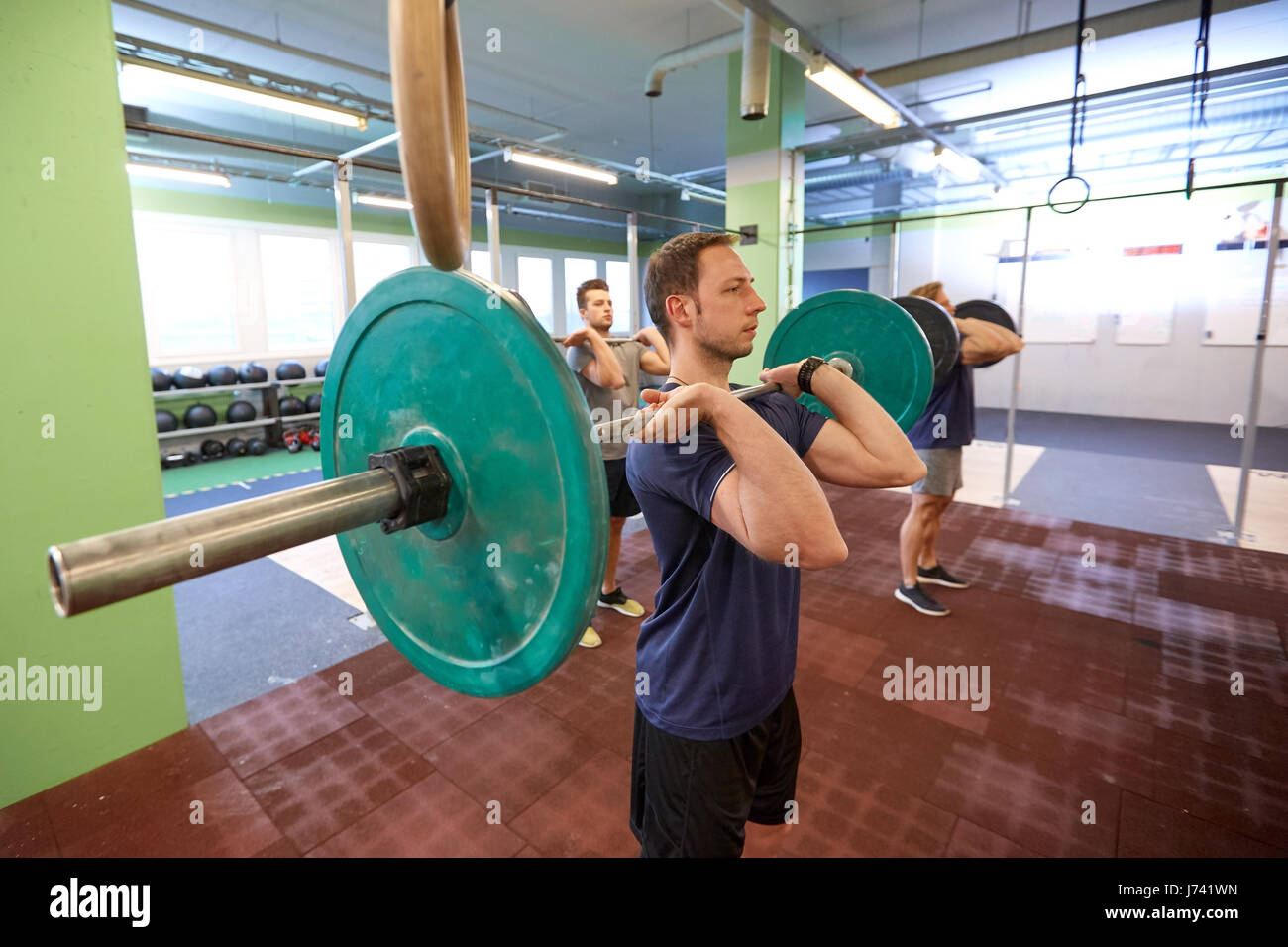 group of men training with barbells in gym Stock Photo - Alamy