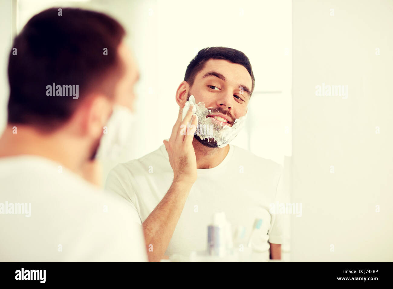 happy man applying shaving foam at bathroom mirror Stock Photo - Alamy