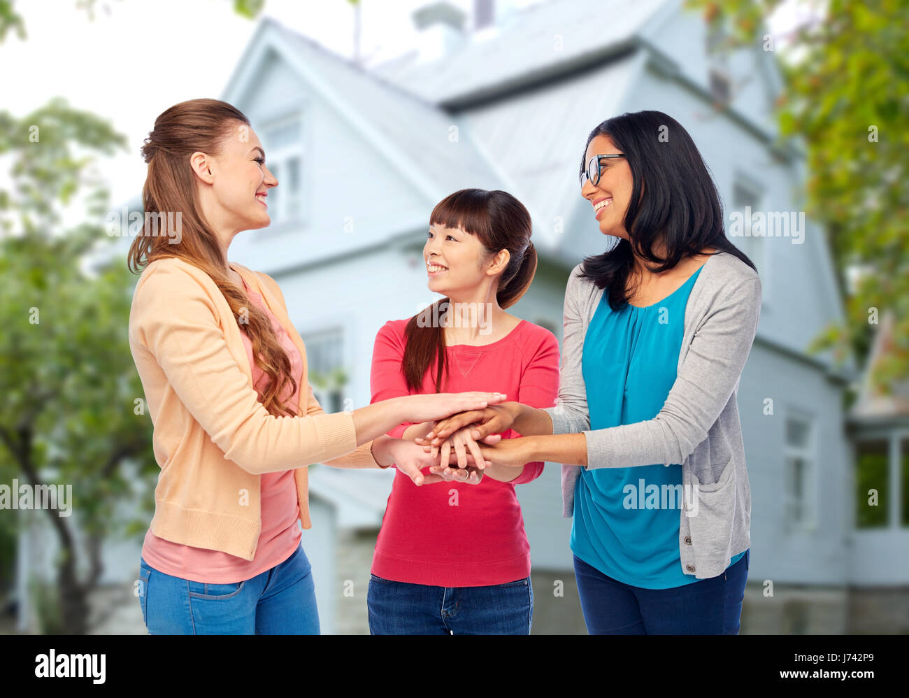 international group of women with hands together Stock Photo - Alamy