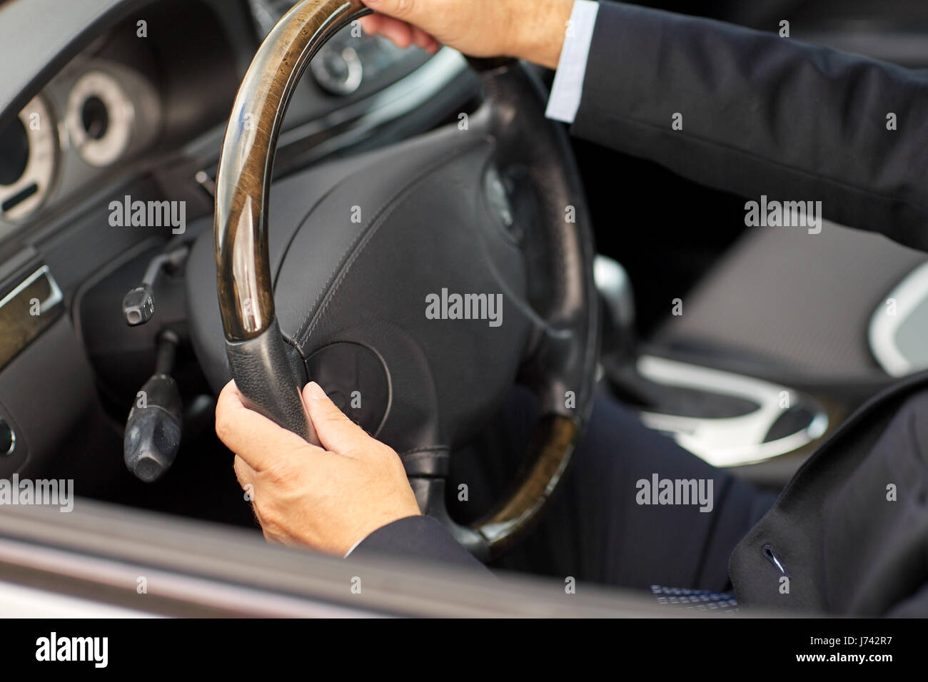 senior businessman hands driving car Stock Photo - Alamy