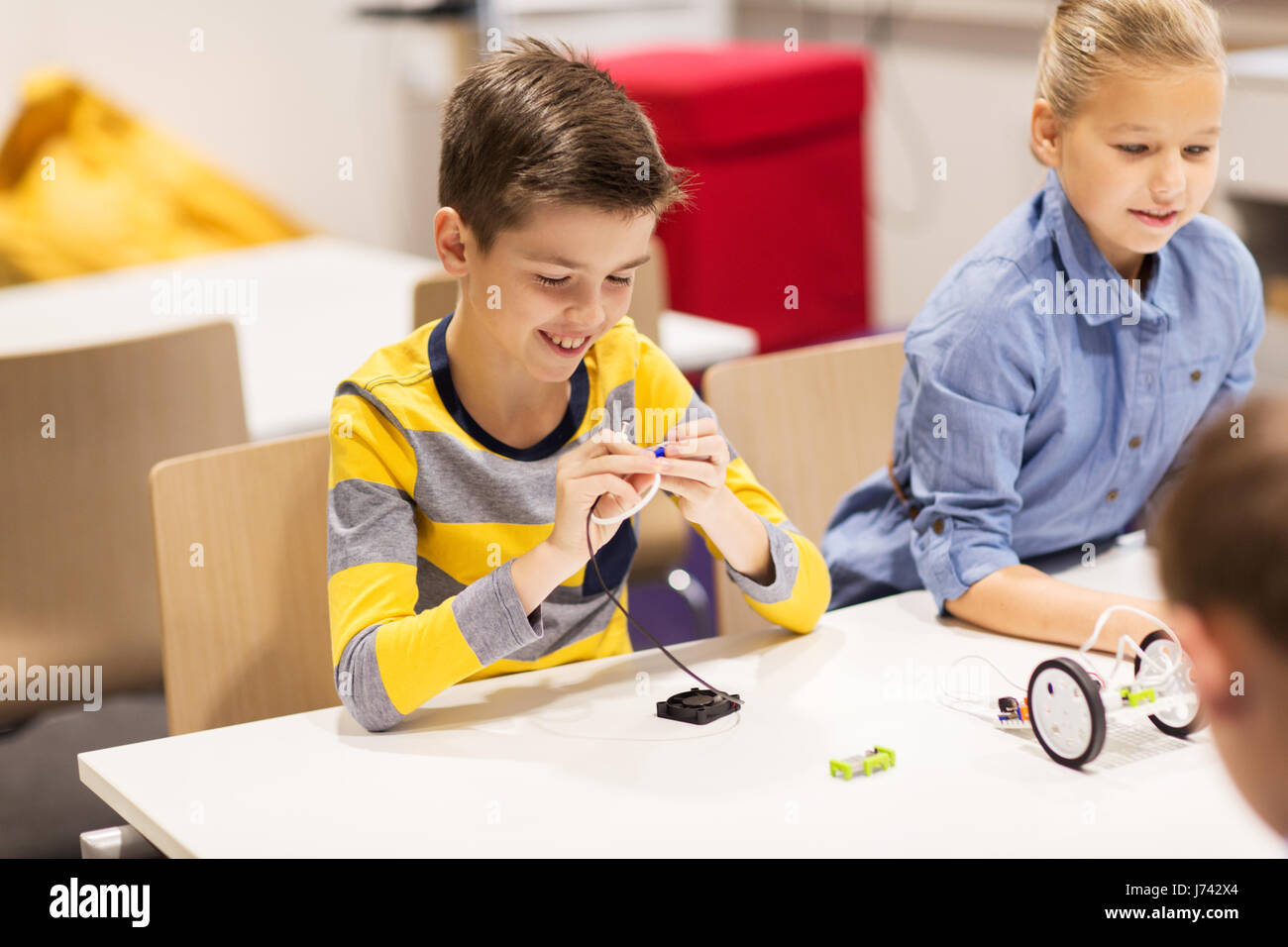 happy children building robots at robotics school Stock Photo - Alamy