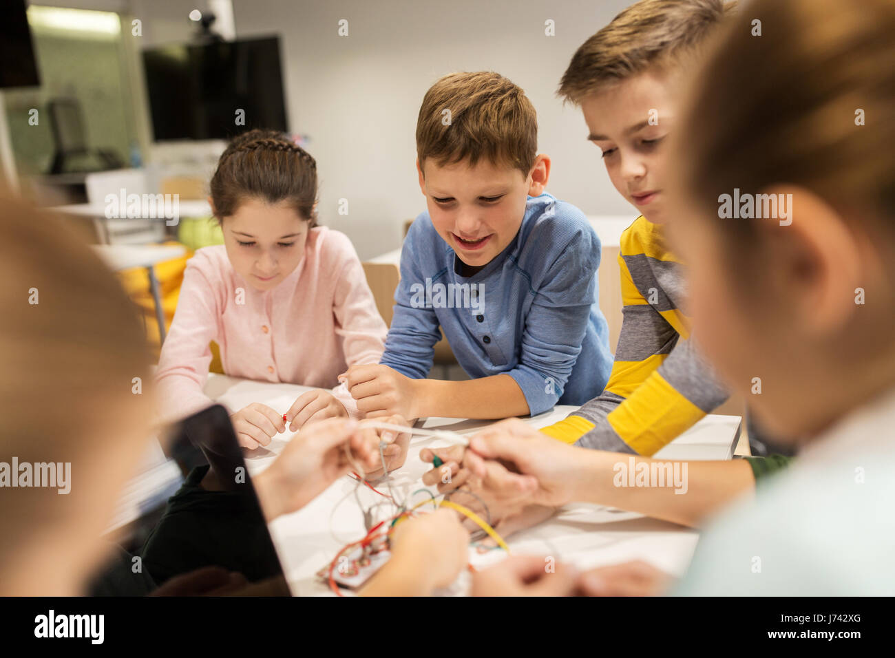 happy kids with invention kit at robotics school Stock Photo - Alamy