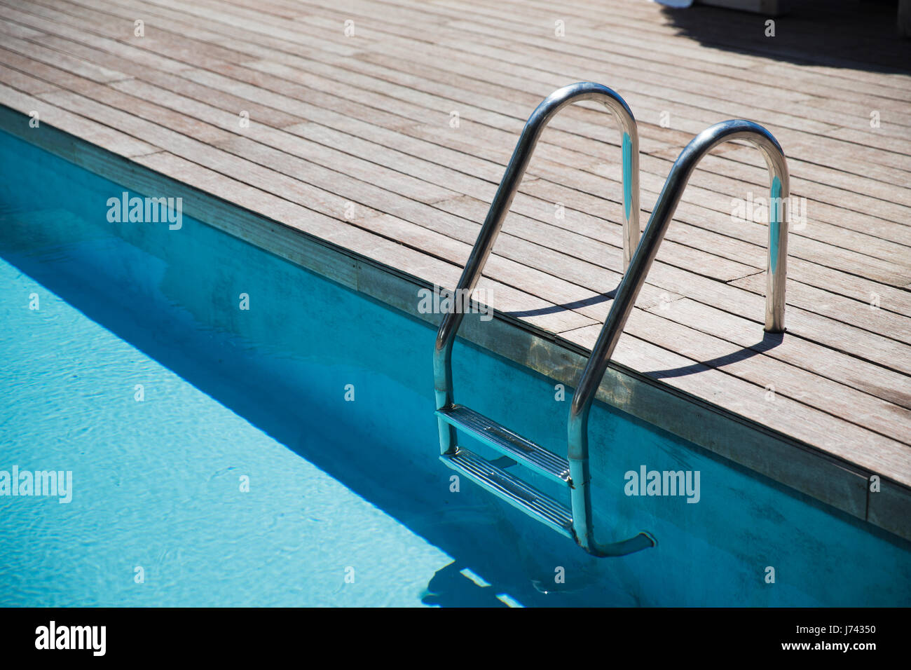 outdoor swimming pool ladder Stock Photo - Alamy