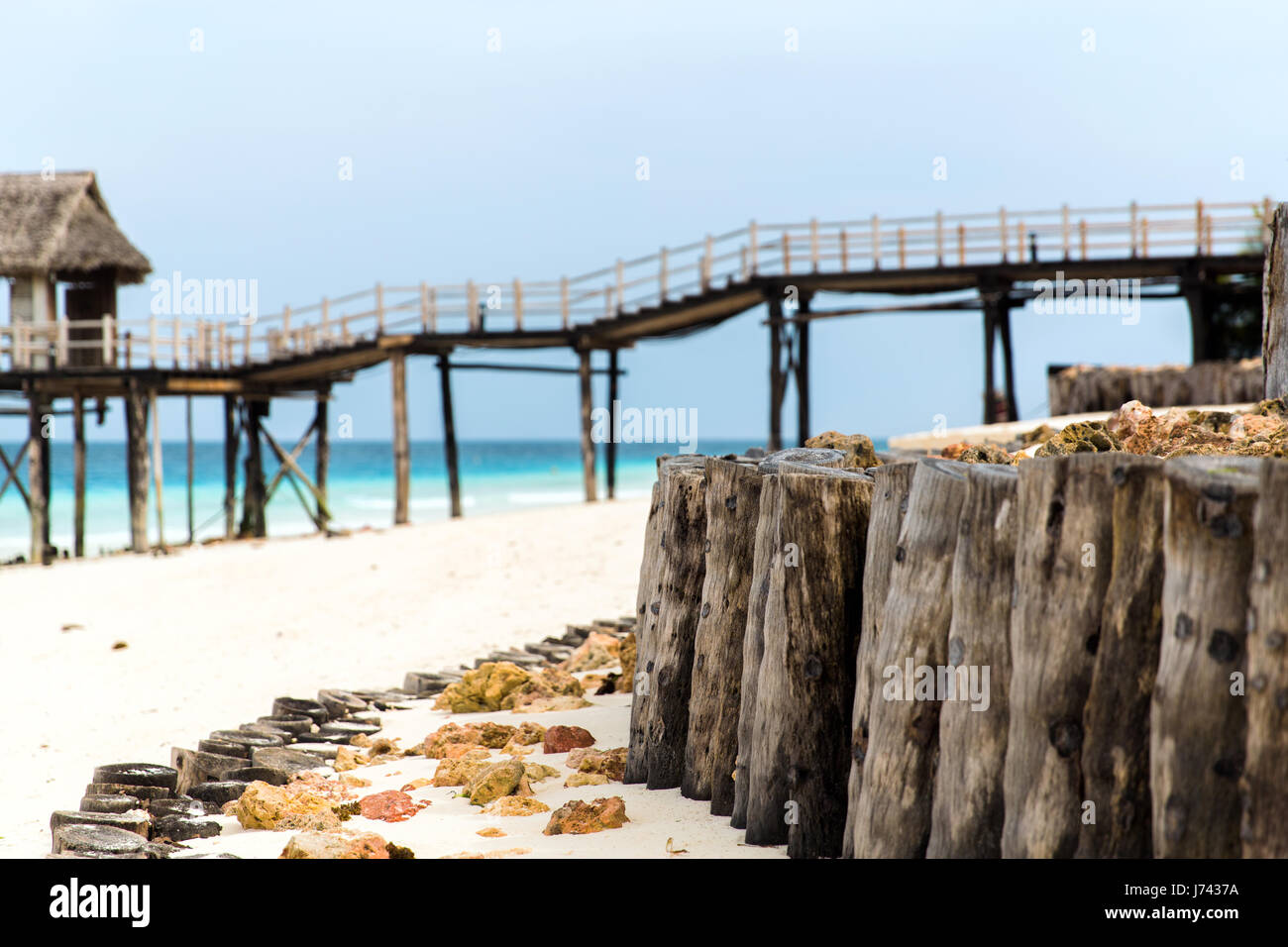 stilt bridge to bungalow hut on tropical beach Stock Photo - Alamy