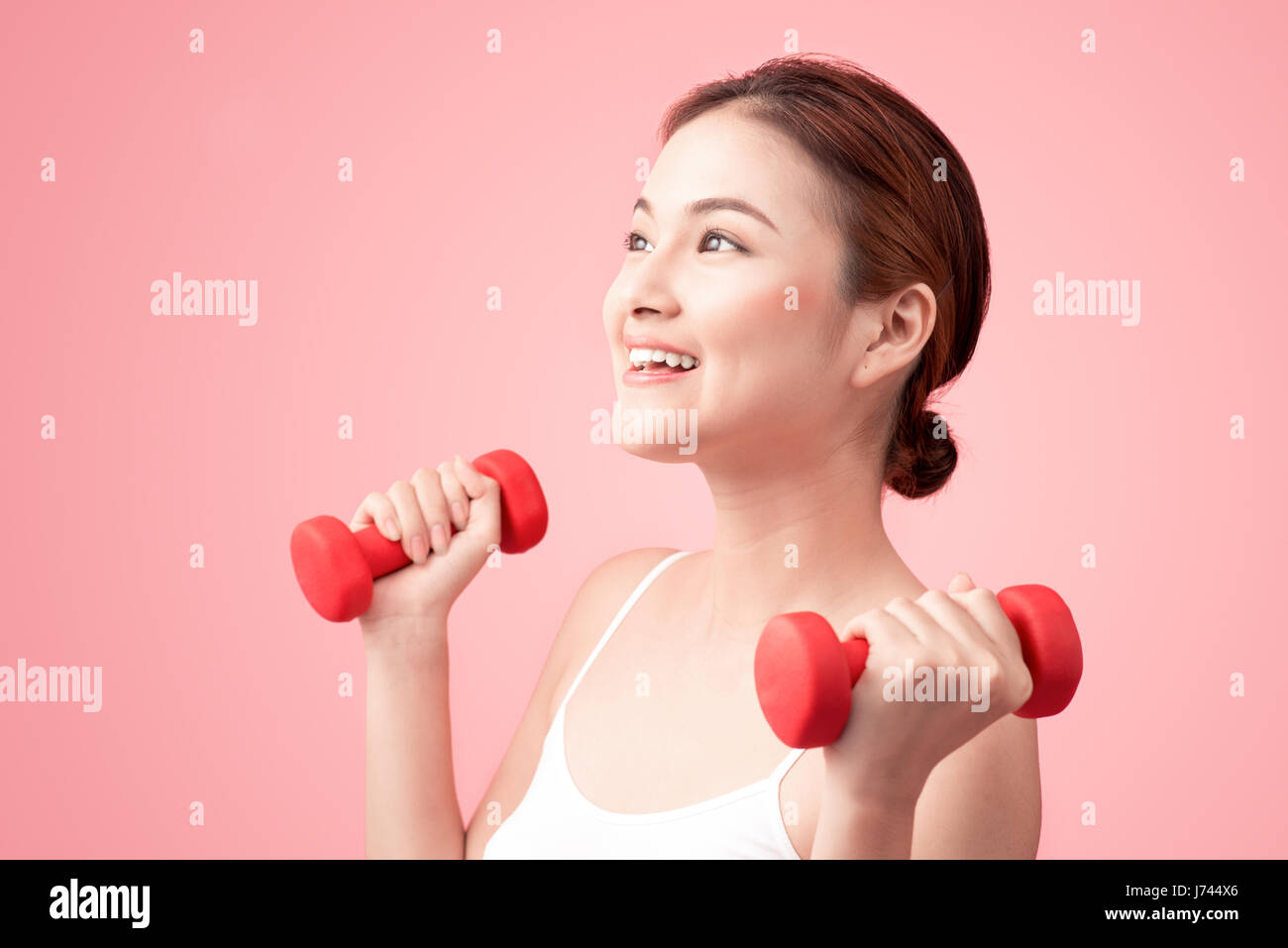 Woman Lifting Weights. Fitness woman lifting weights smiling happy on ...