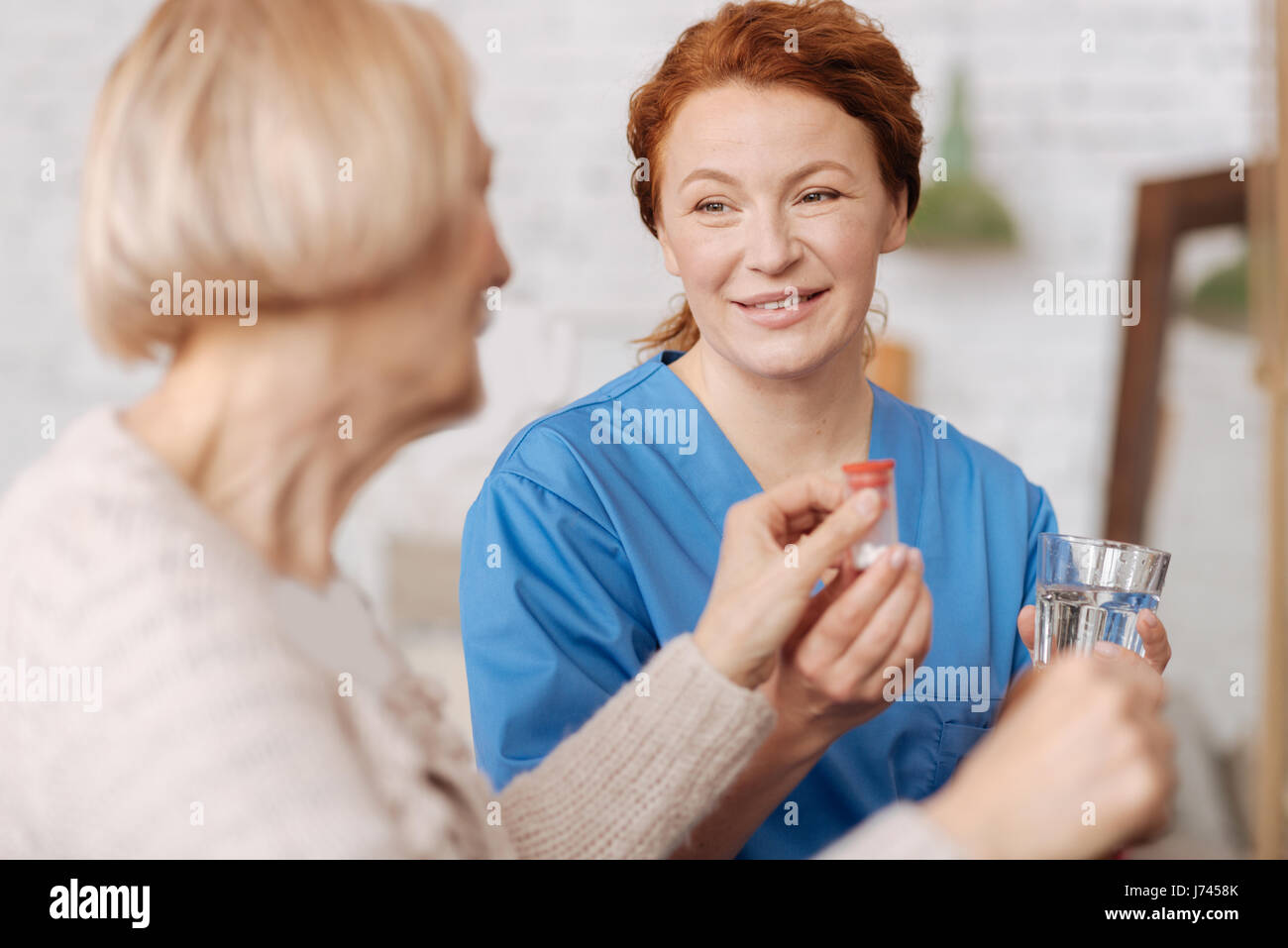 Diligent nurse making sure her patient taking medication Stock Photo ...