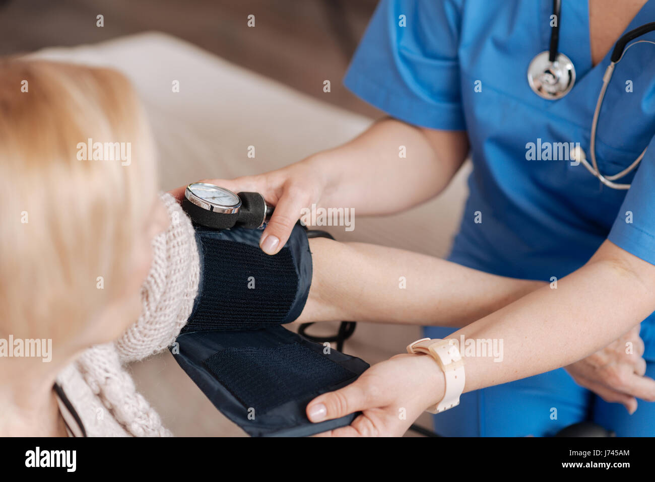 Careful patient doctor providing medical service at home Stock Photo ...