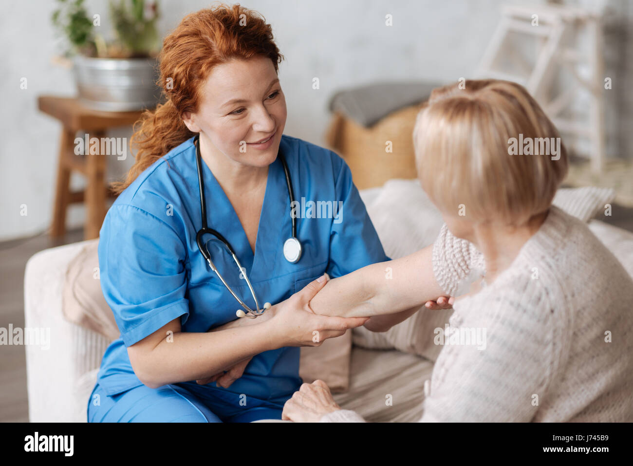 Experienced gentle private doctor testing patients joints Stock Photo ...