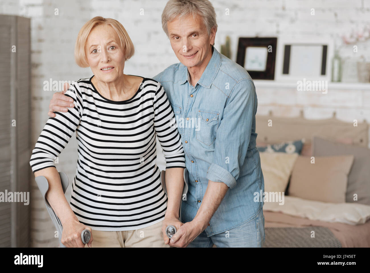 Supportive charming man helping his lady recovering Stock Photo - Alamy