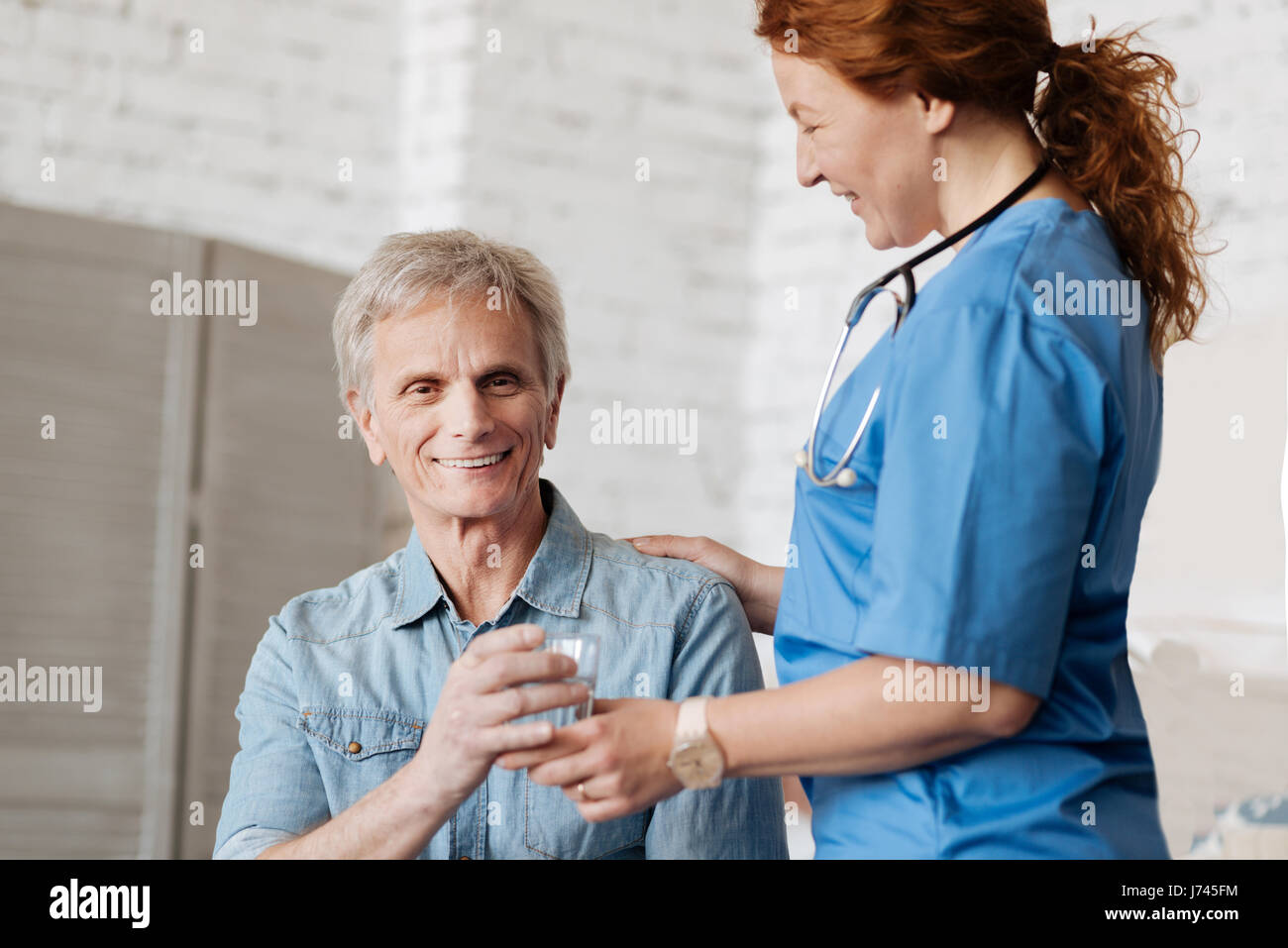 Handsome elderly man delighted with the services he receiving Stock ...