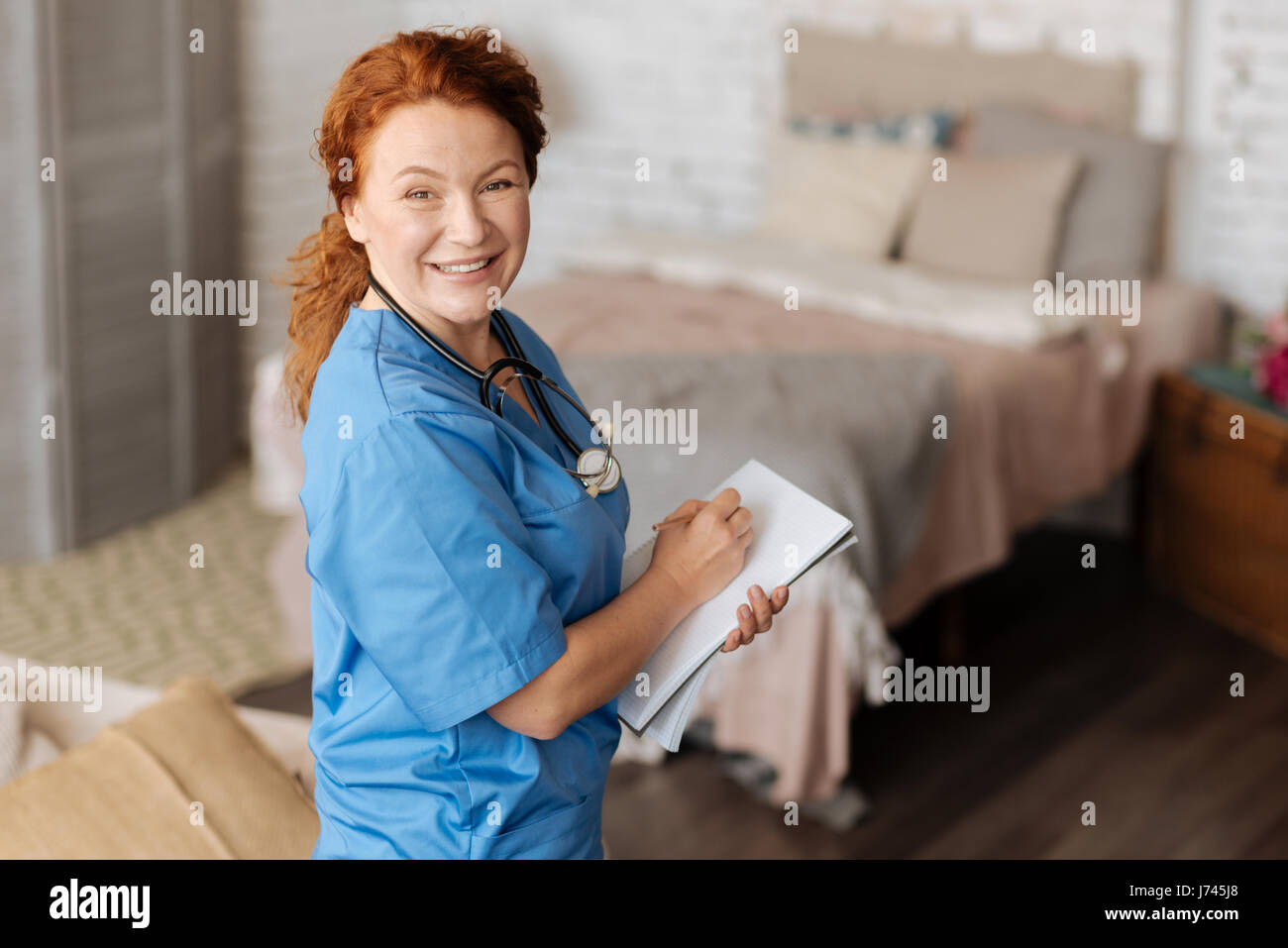 Dedicated mindful doctor noting important data in her journal Stock ...