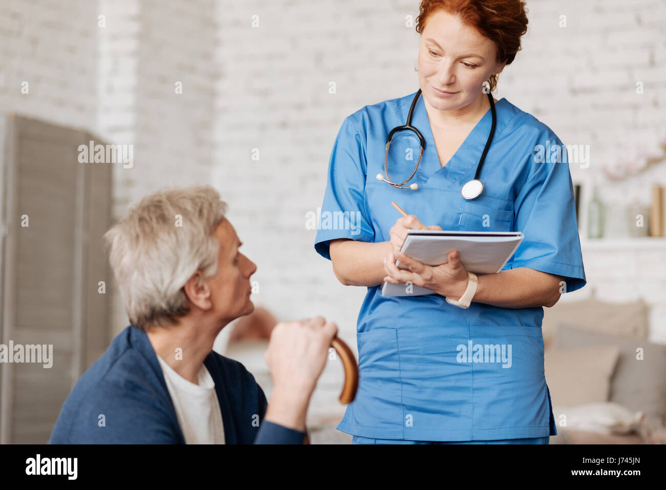 Neat mindful doctor hearing out her patient Stock Photo - Alamy