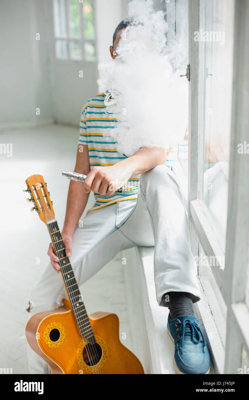 The face of vaping young man Stock Photo - Alamy