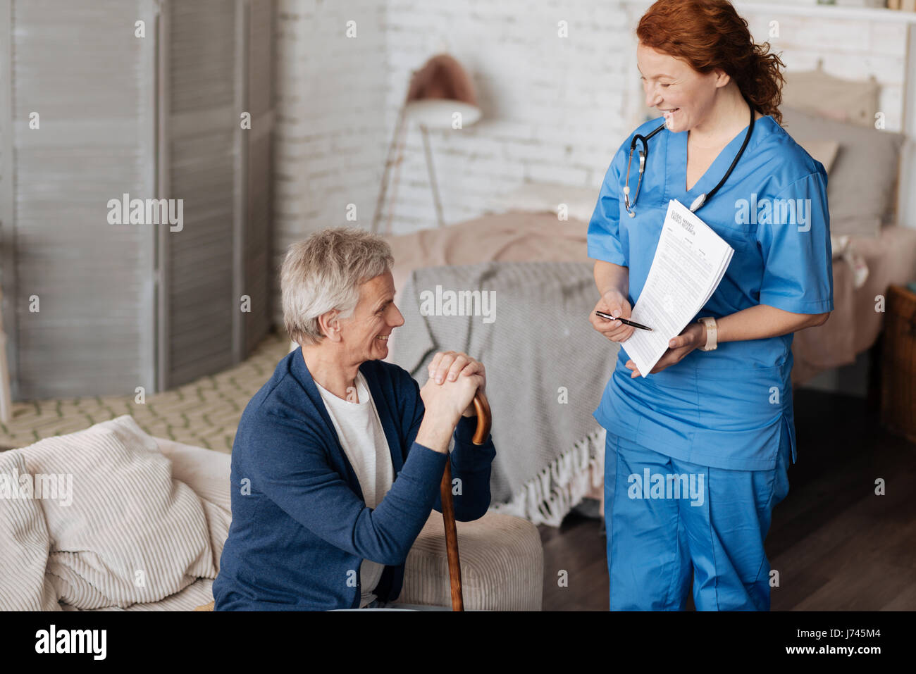 Energetic clever doctor educating her mature patient Stock Photo - Alamy