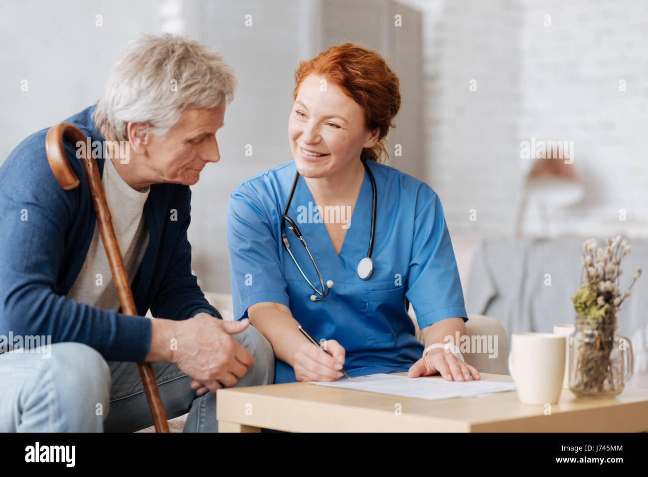Lovely trained nurse explaining specifics of her work Stock Photo - Alamy