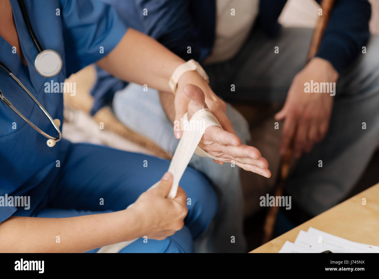Gentle experienced doctor treating her patients injury Stock Photo - Alamy