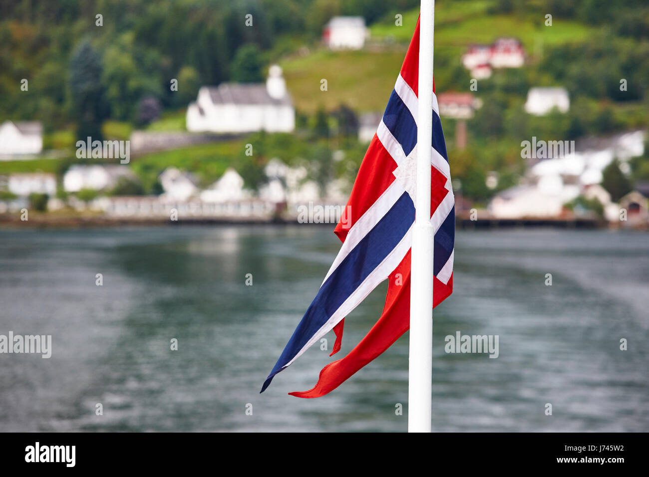 Norwegian flag. Norway fjord landscape with green hill and houses ...