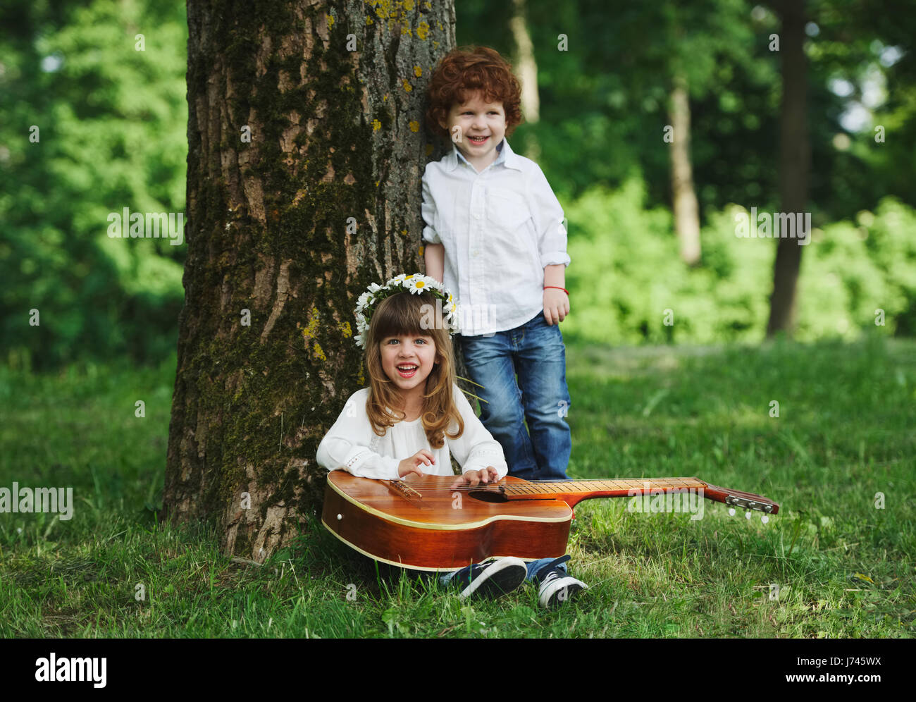 cute little children playing guitar Stock Photo - Alamy
