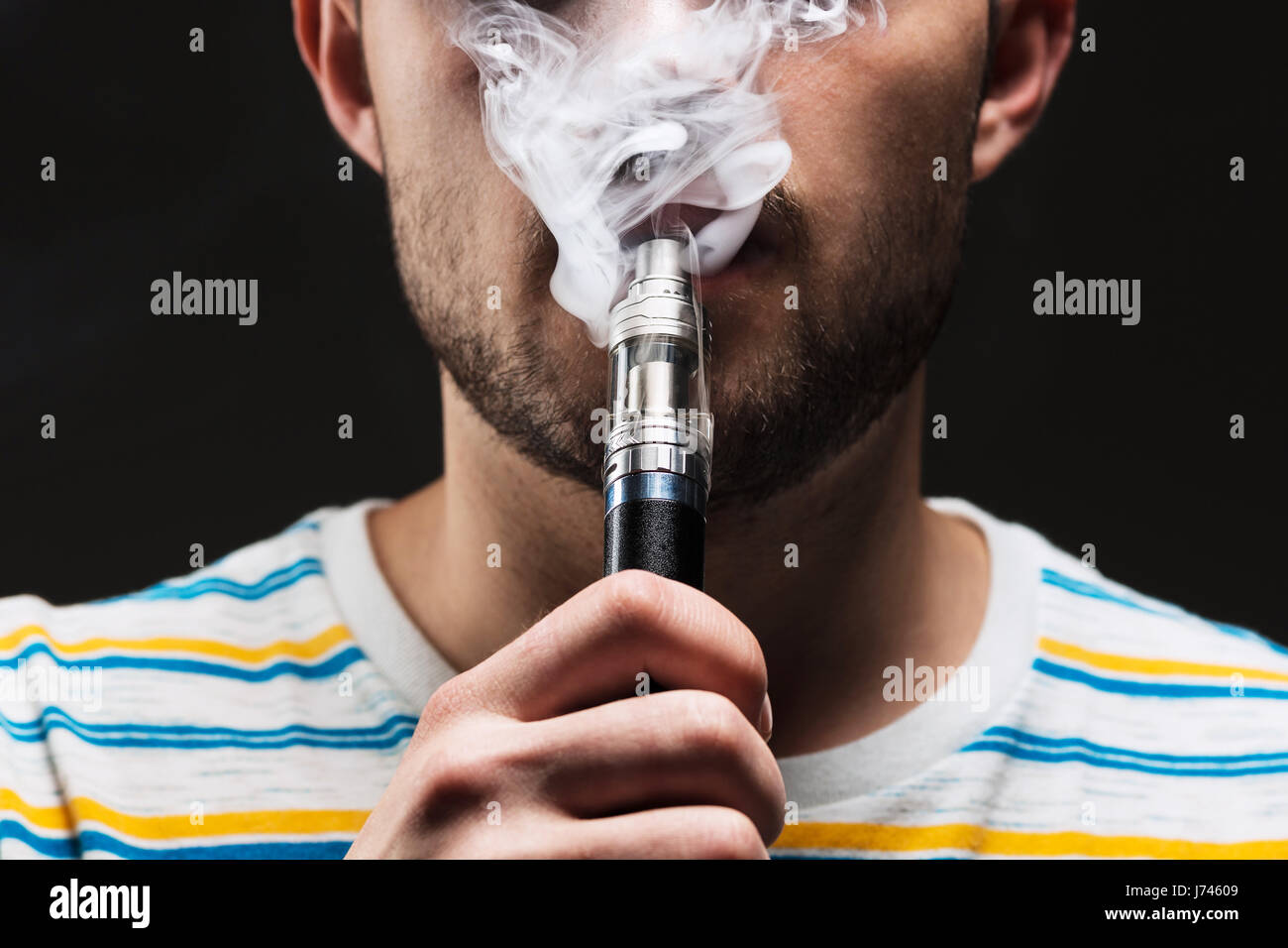 The face of vaping young man Stock Photo - Alamy