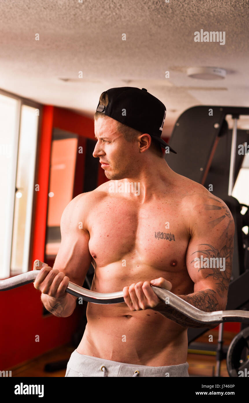 Handsome muscular man working out at gym Stock Photo - Alamy