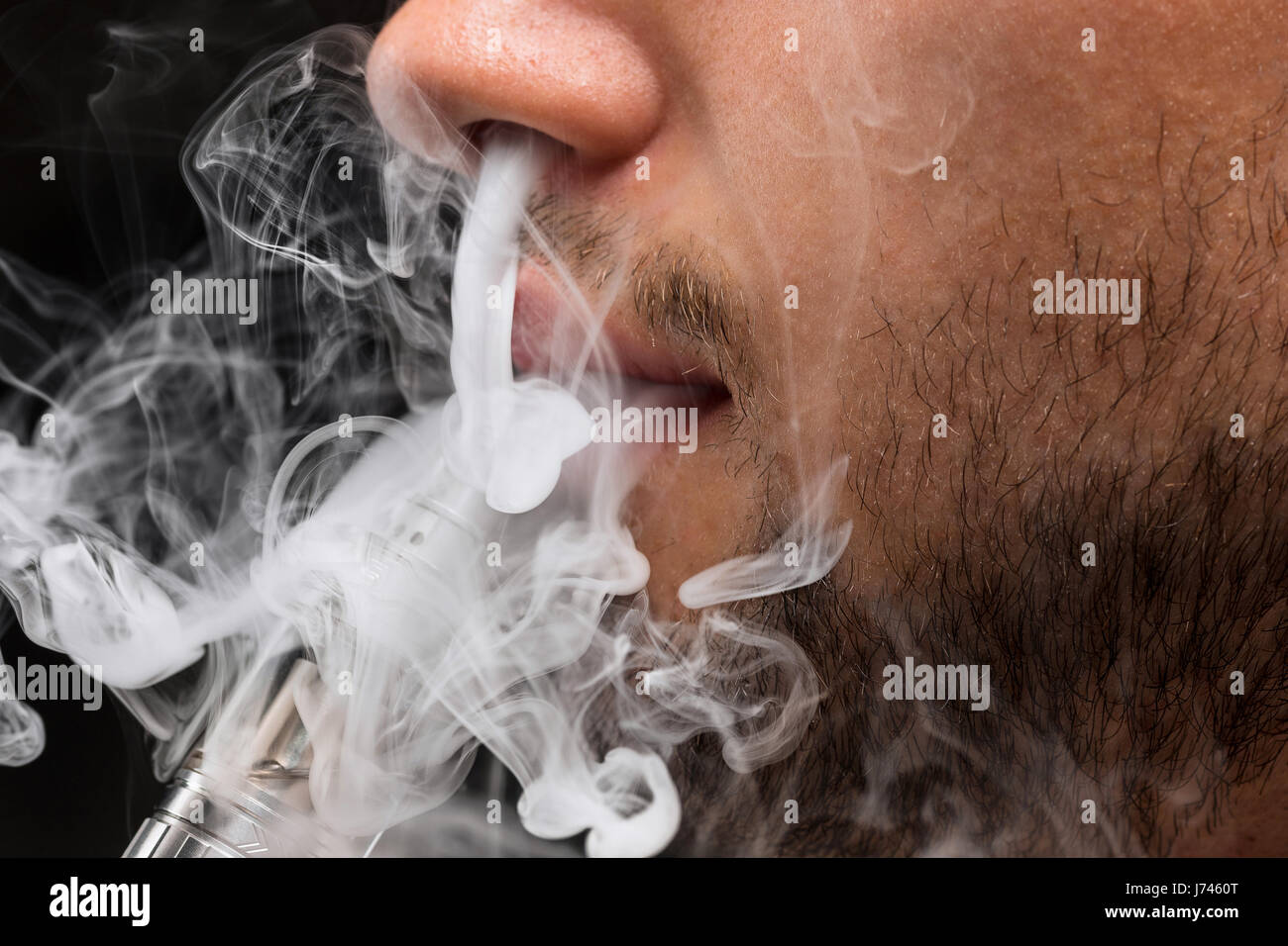 The face of vaping young man Stock Photo - Alamy