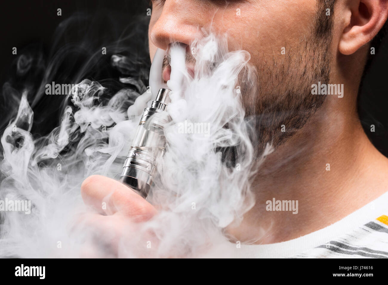 The face of vaping young man Stock Photo - Alamy