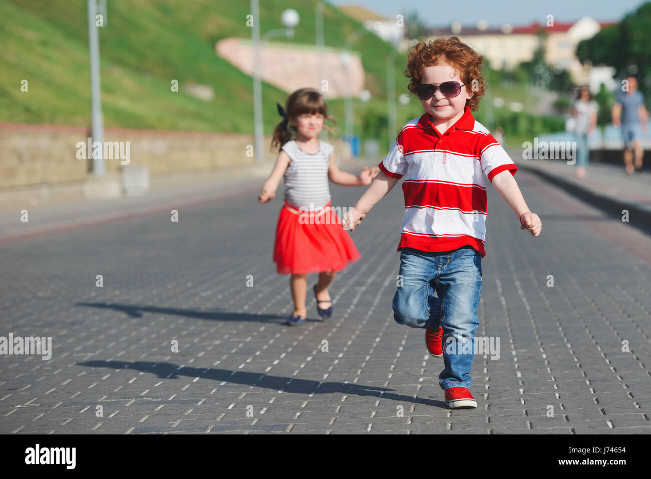 two happy children running on the promenade Stock Photo - Alamy