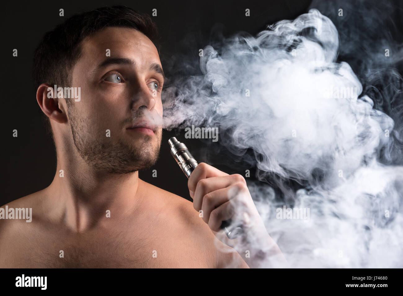 The face of vaping young man Stock Photo - Alamy