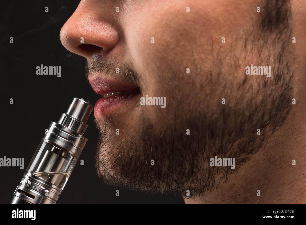 The face of vaping young man Stock Photo - Alamy