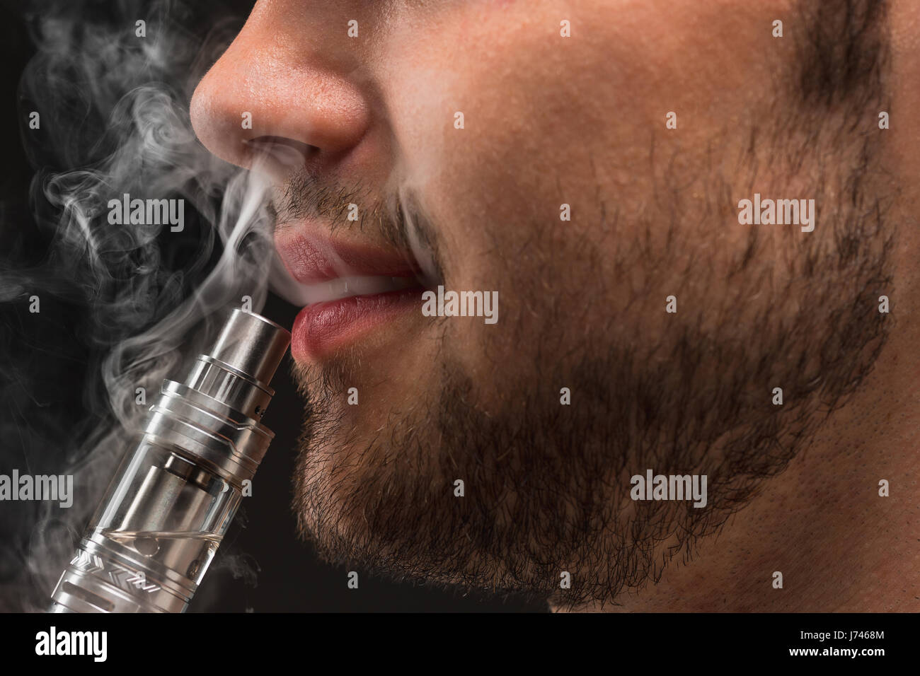 The face of vaping young man Stock Photo - Alamy