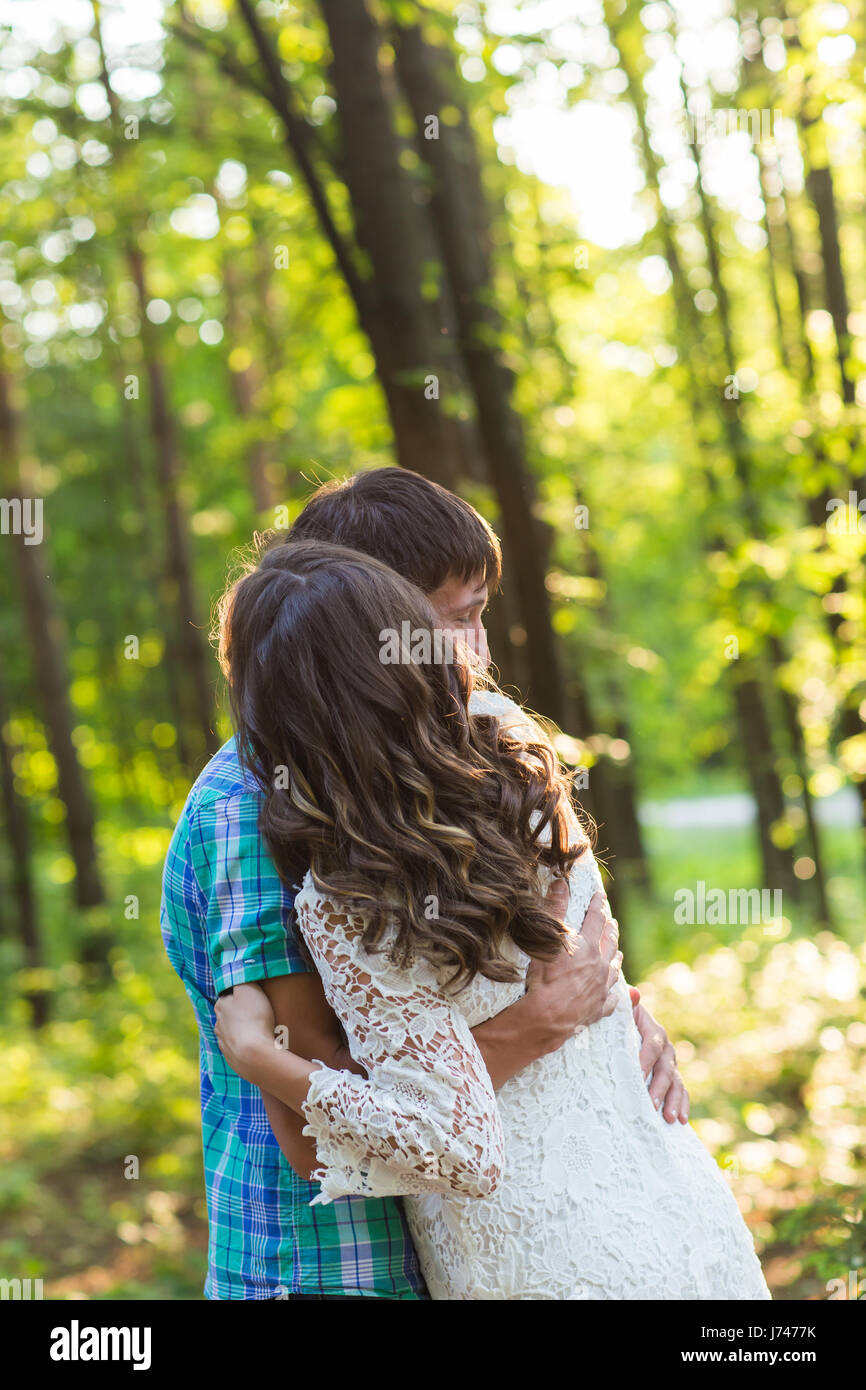 Portrait of a young romantic couple embracing each other on nature ...