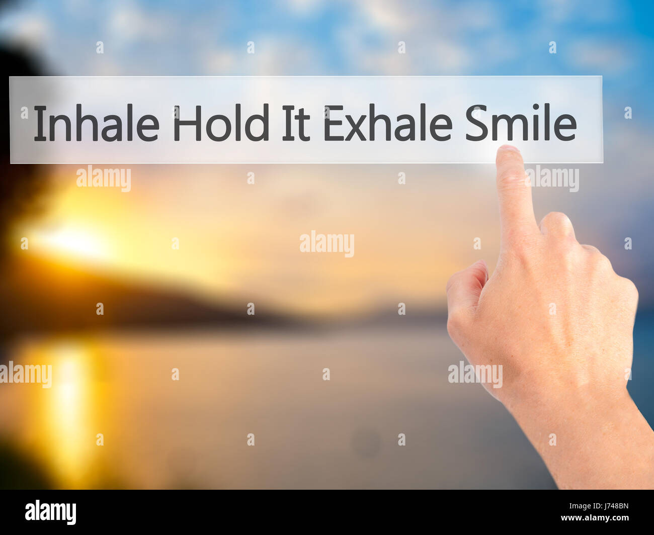 Inhale Hold It Exhale Smile - Hand pressing a button on blurred ...