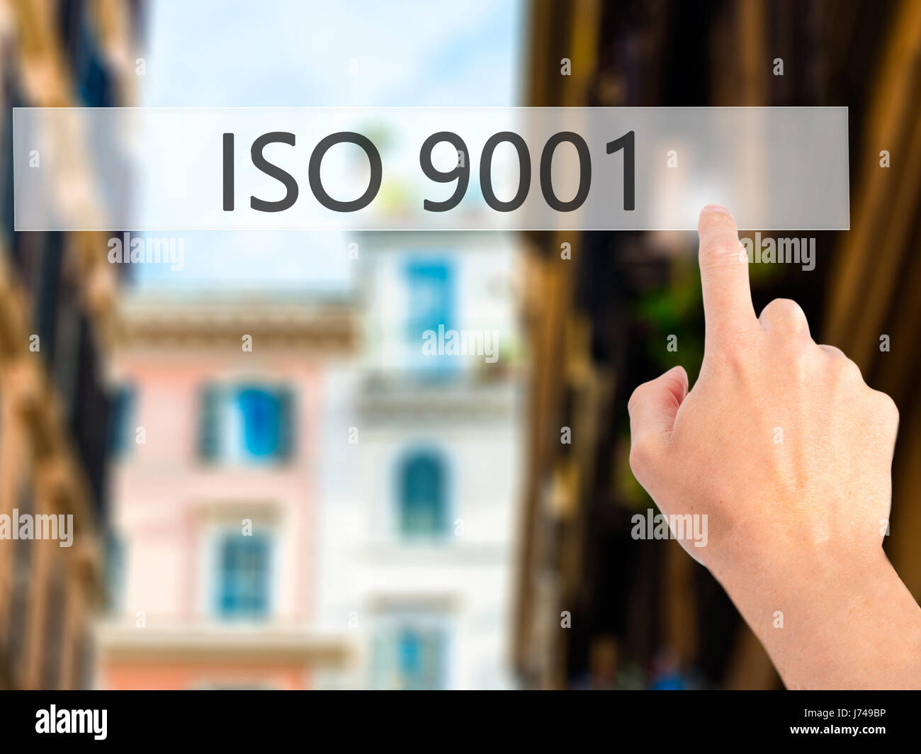 ISO 9001 - Hand pressing a button on blurred background concept ...