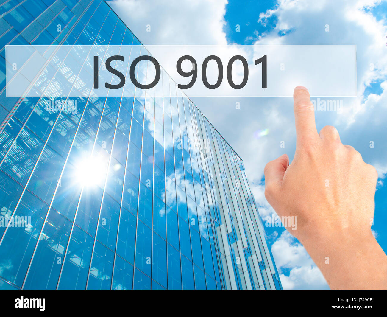 ISO 9001 - Hand pressing a button on blurred background concept ...