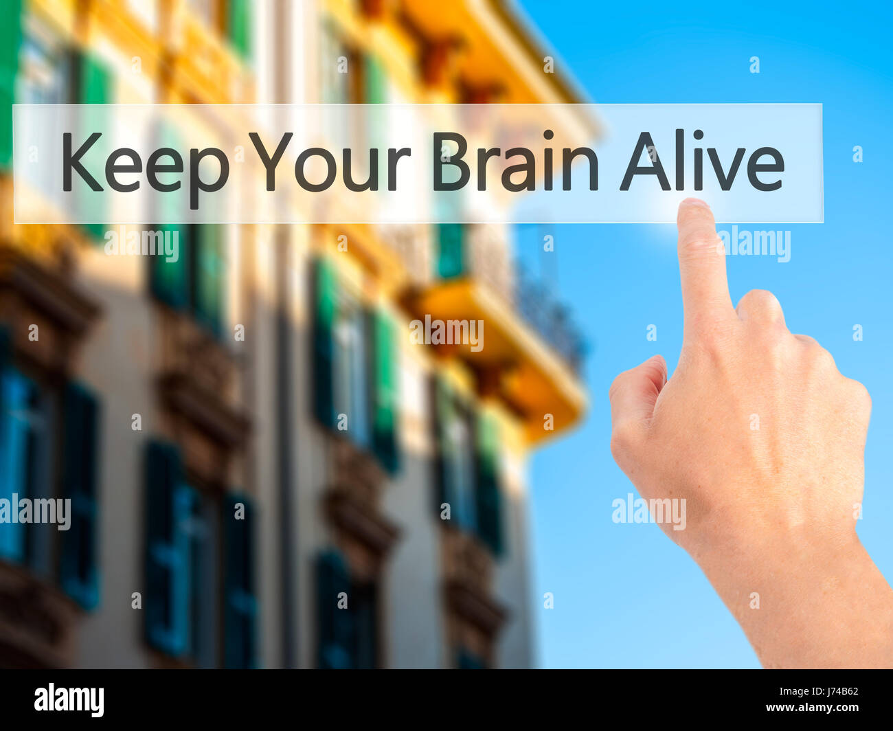 Keep Your Brain Alive - Hand pressing a button on blurred background ...