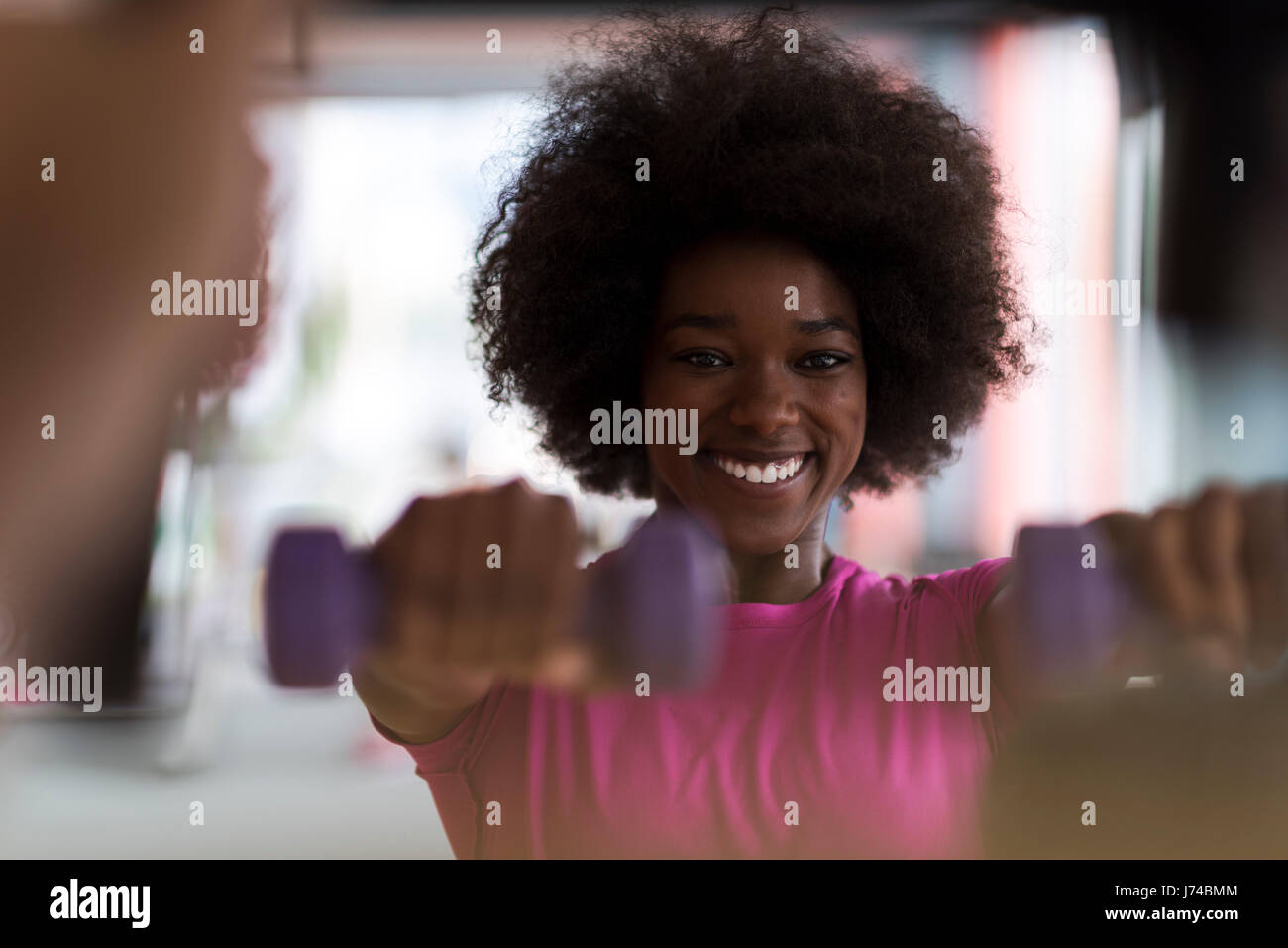 happy healthy african american woman working out in a crossfit gym on ...