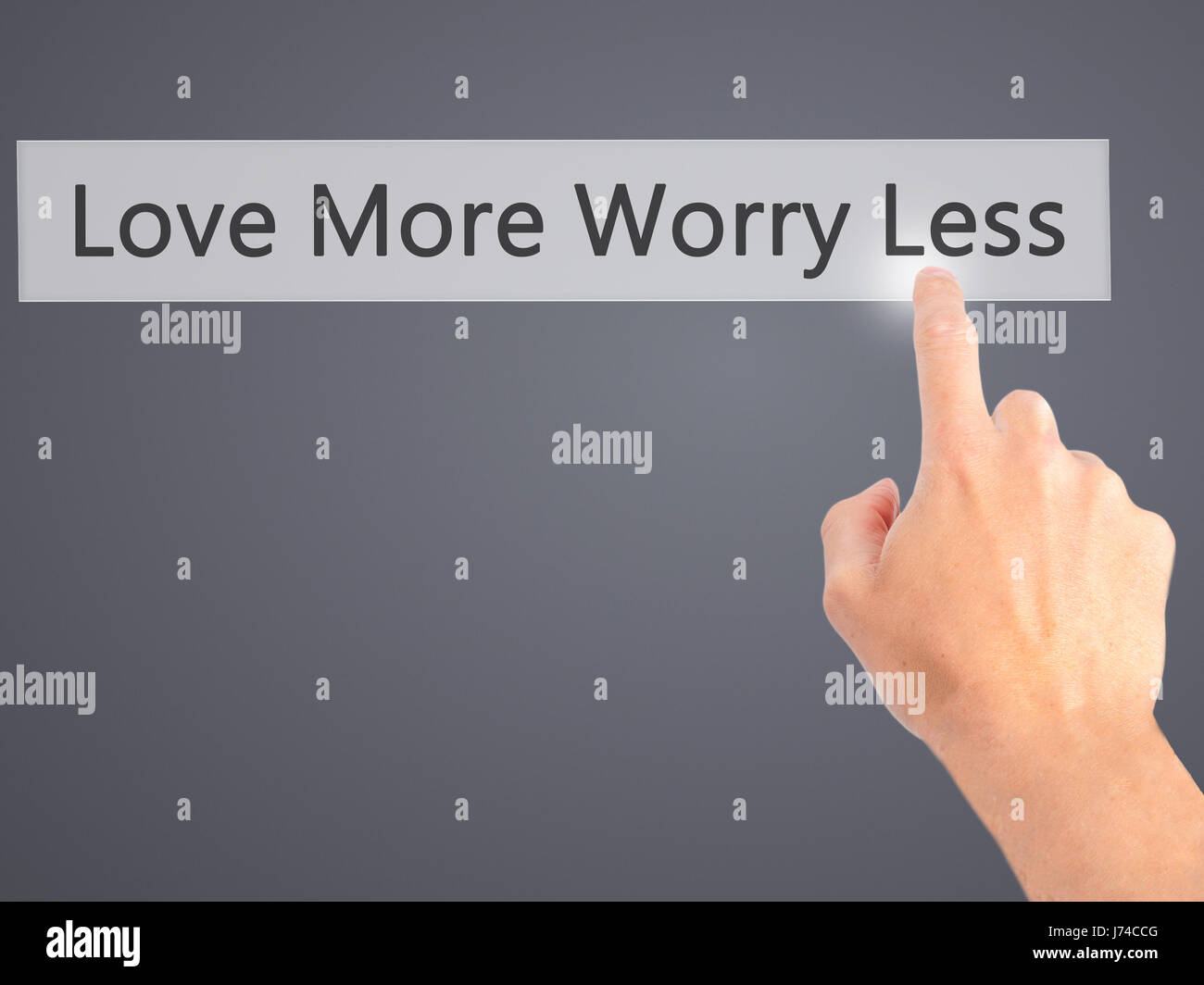 Love More Worry Less - Hand pressing a button on blurred background ...