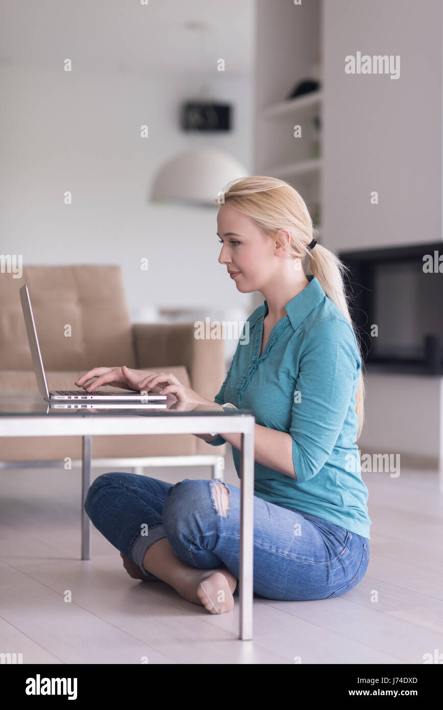 beautiful young women using laptop computer on the floor of her luxury ...
