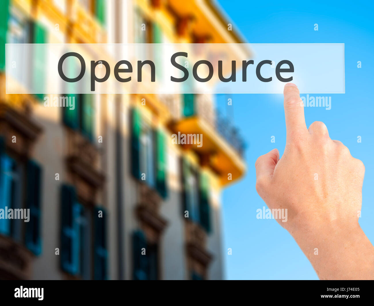 Open Source - Hand pressing a button on blurred background concept . Business, technology ...