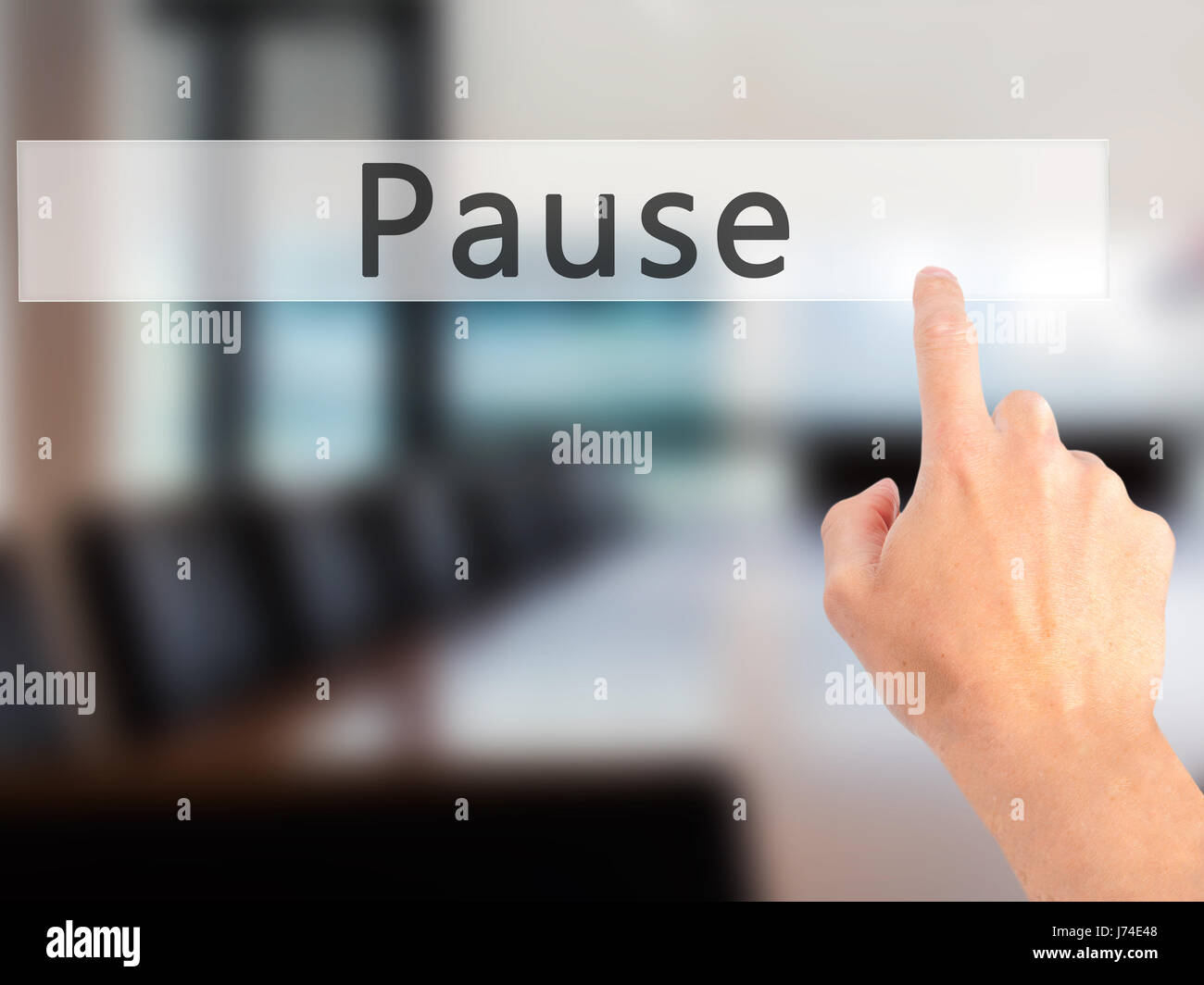 Pause - Hand pressing a button on blurred background concept . Business ...