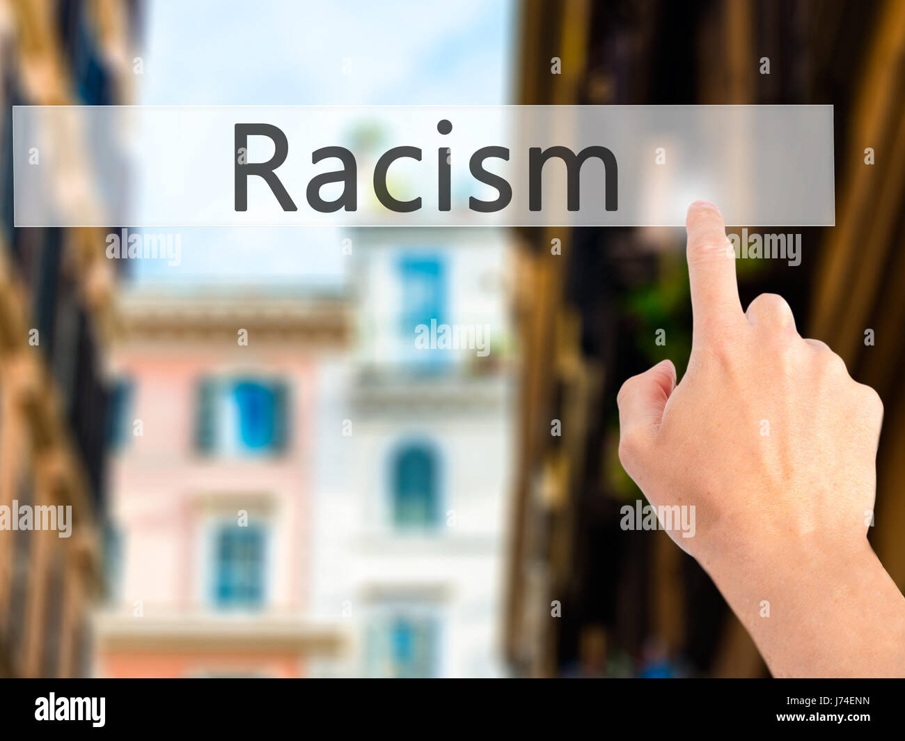 Racism - Hand pressing a button on blurred background concept ...