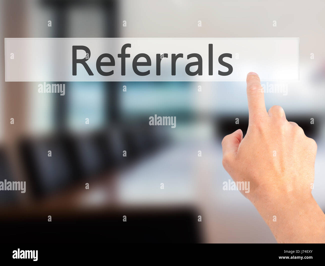 Referrals - Hand pressing a button on blurred background concept ...