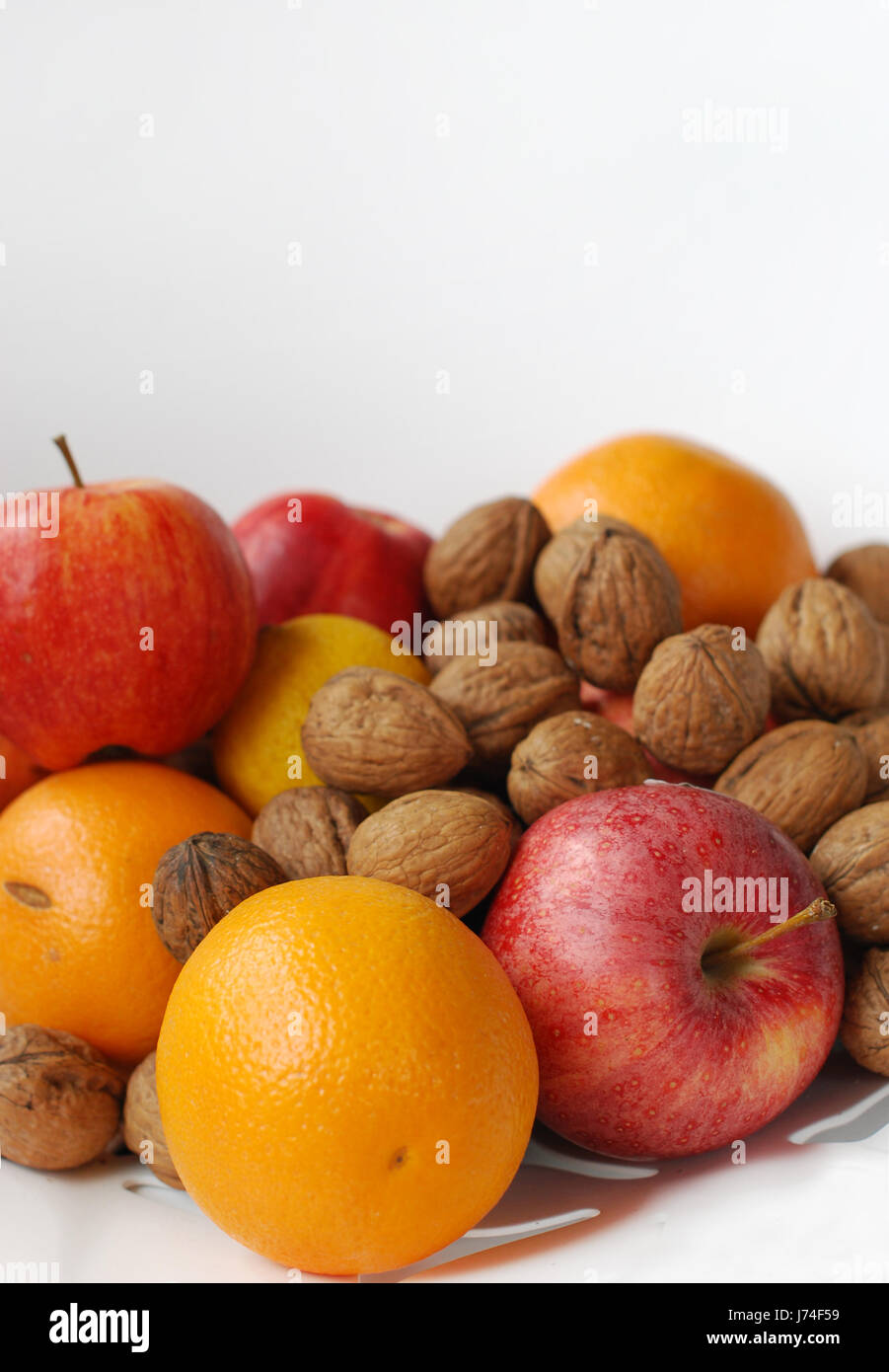 orange apples apple nut walnut lemon citron citrus isolated coloured colourful Stock Photo - Alamy