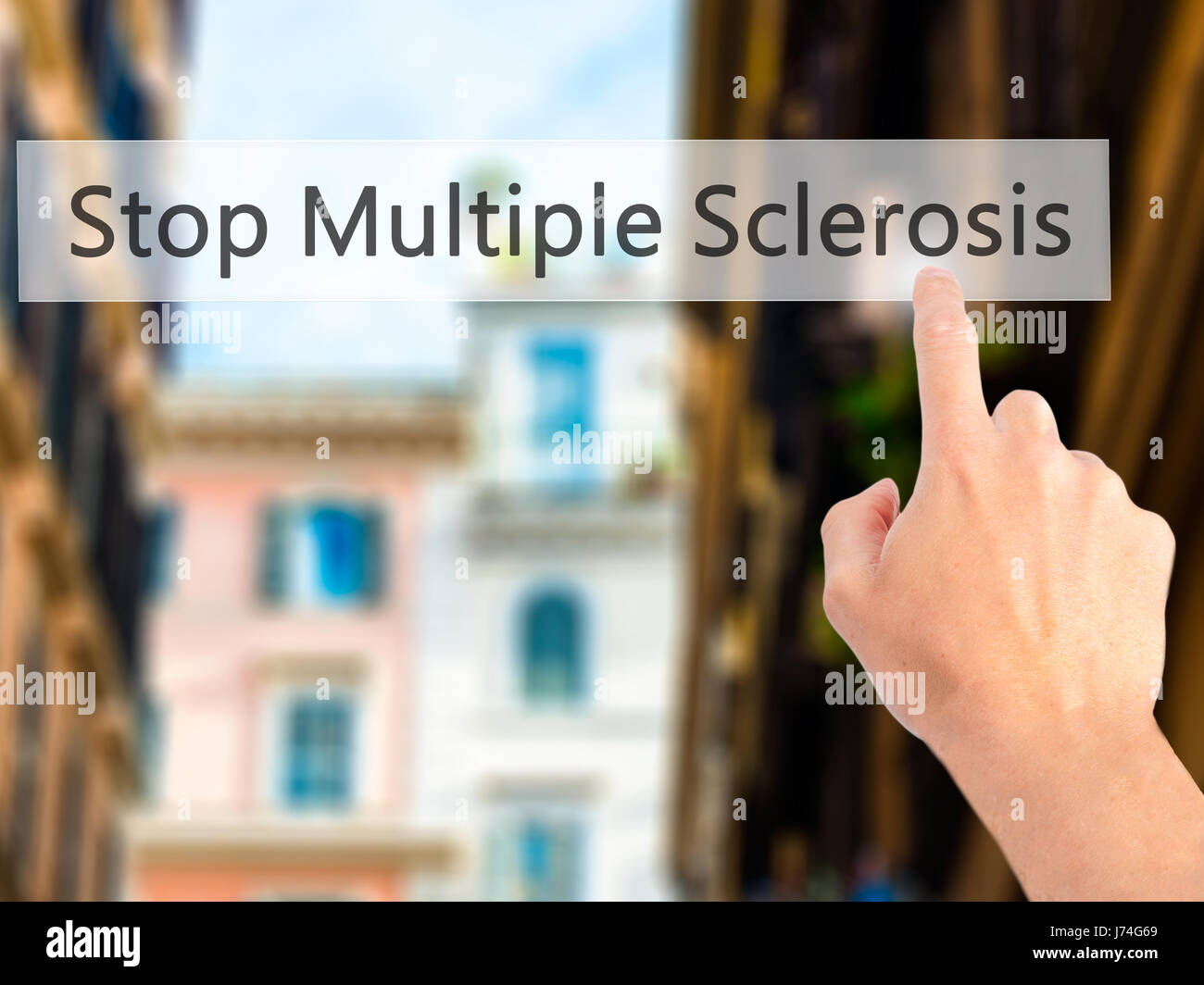 Stop Multiple Sclerosis - Hand pressing a button on blurred background ...