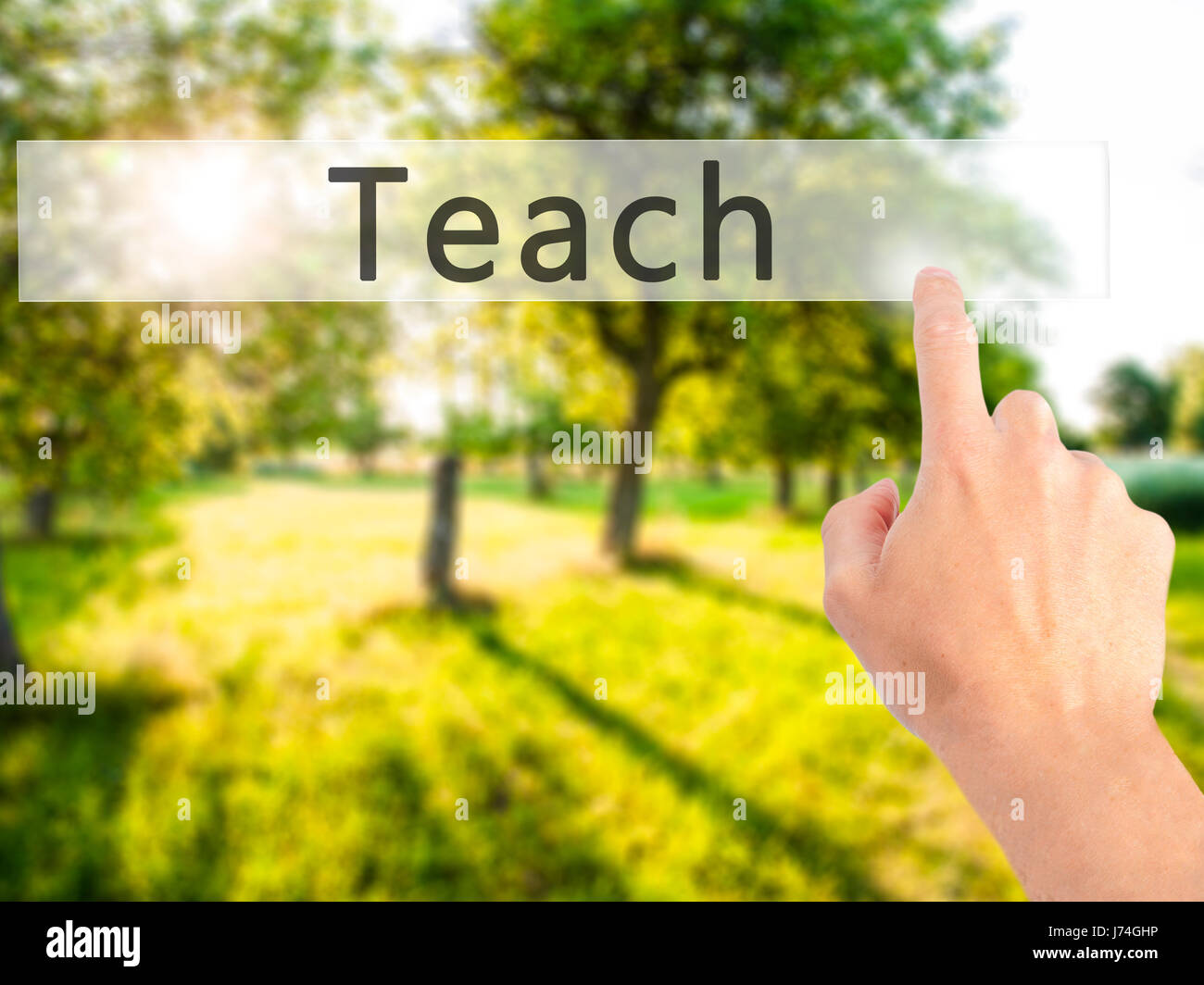 Teach - Hand pressing a button on blurred background concept . Business ...