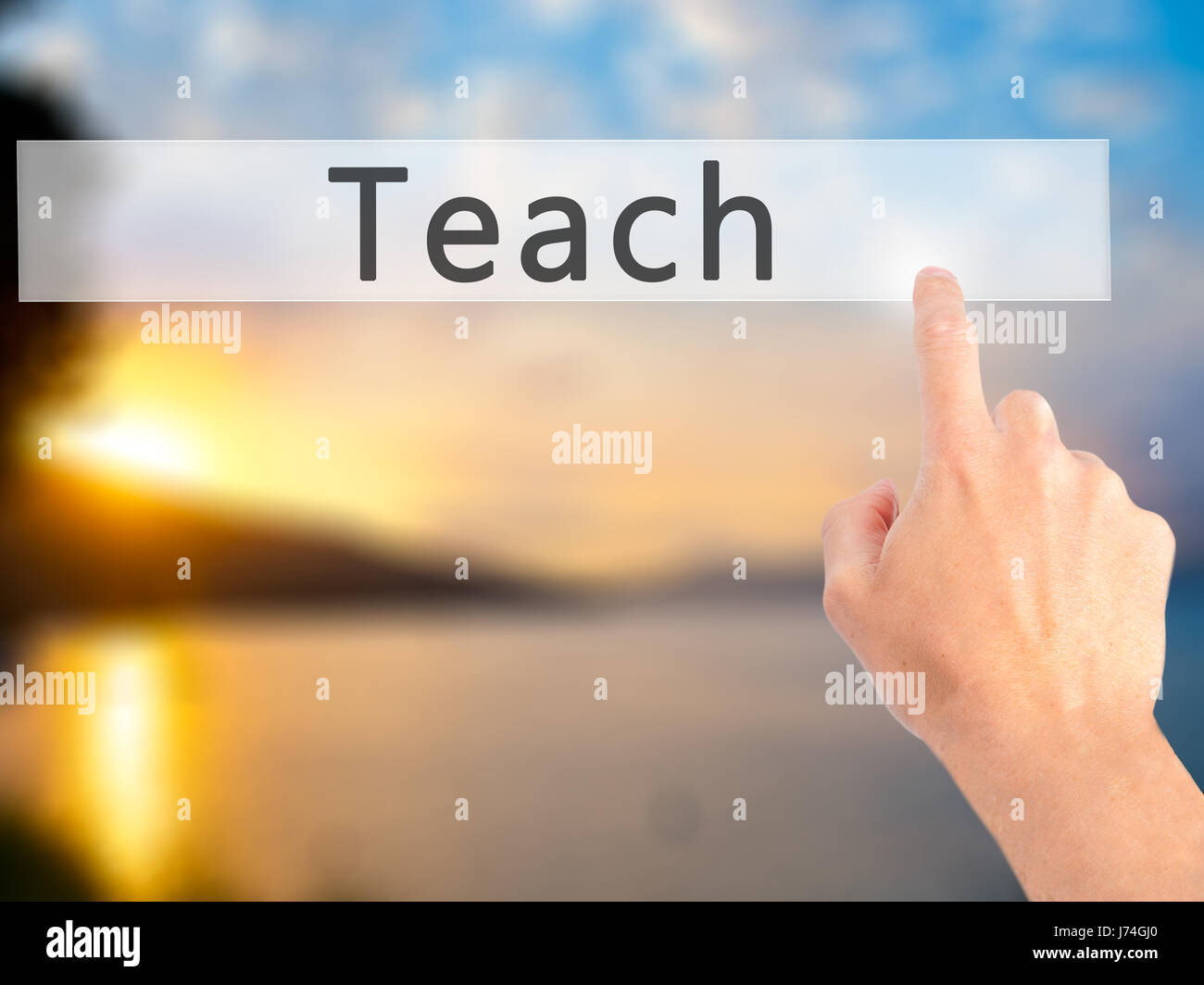 Teach - Hand pressing a button on blurred background concept . Business ...